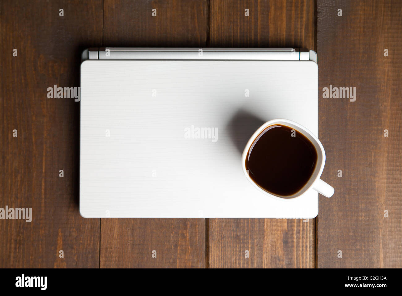 Cup of coffee on laptop Stock Photo - Alamy