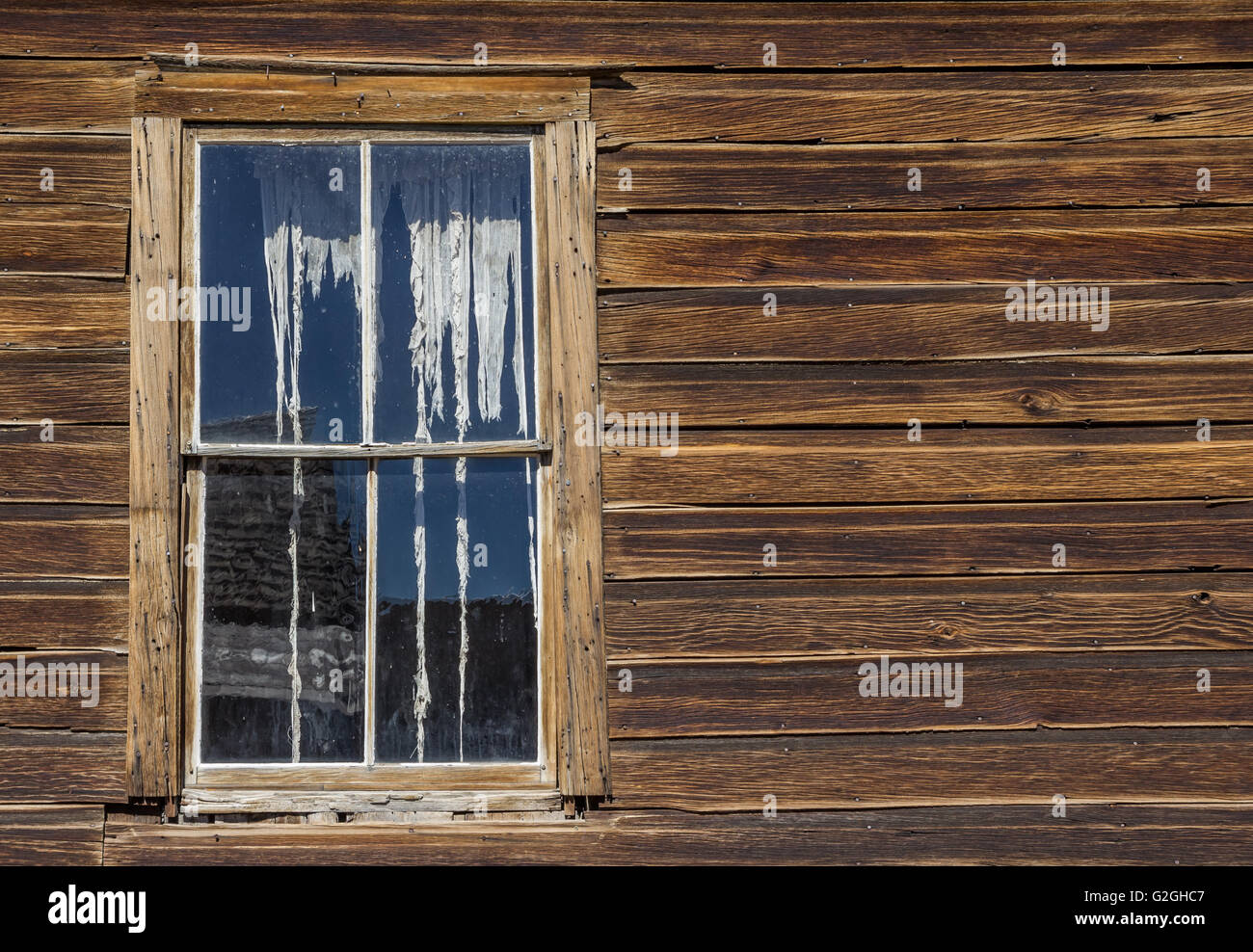 Window and ripped curtains of a house in Bodie State Historic Park, USA ...