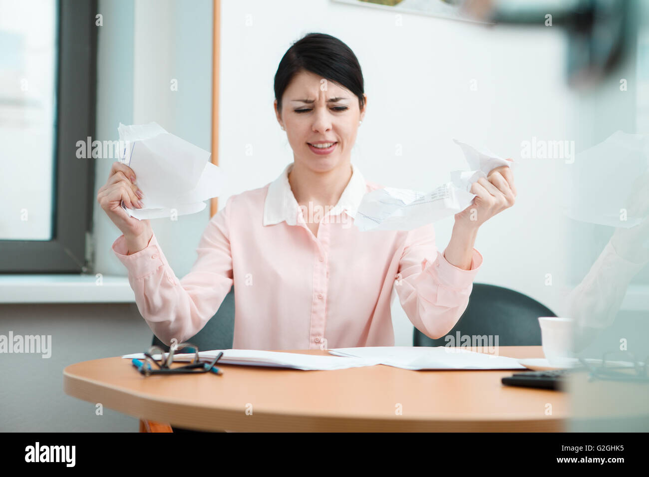 Woman in office with crumpled paper Stock Photo - Alamy