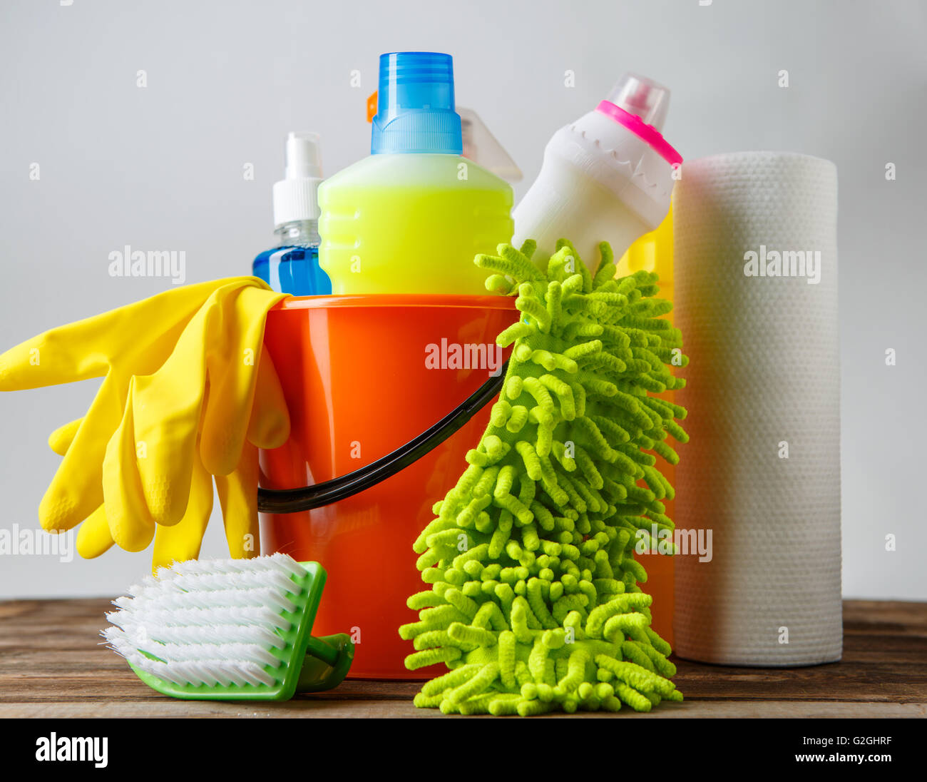 Bucket with cleaning items on light background Stock Photo - Alamy