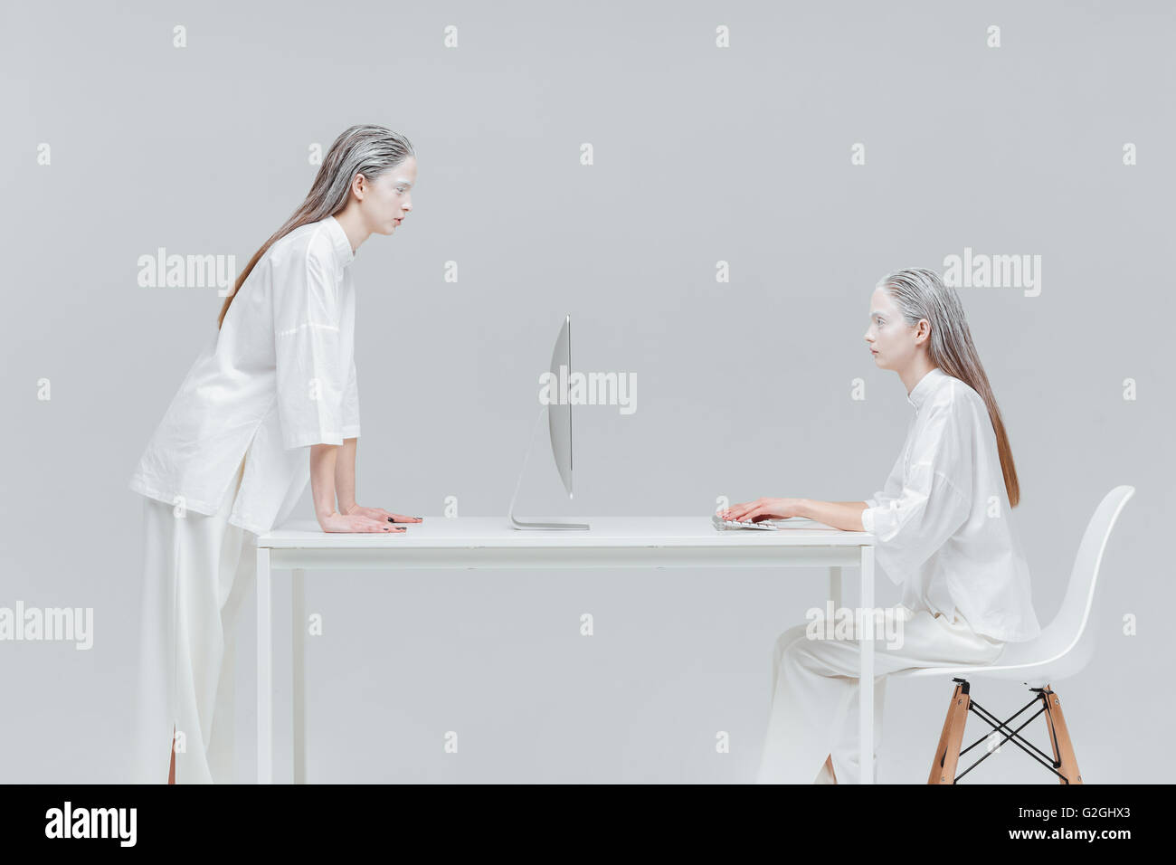 Two beautiful women using future technology, computer and looking at ...