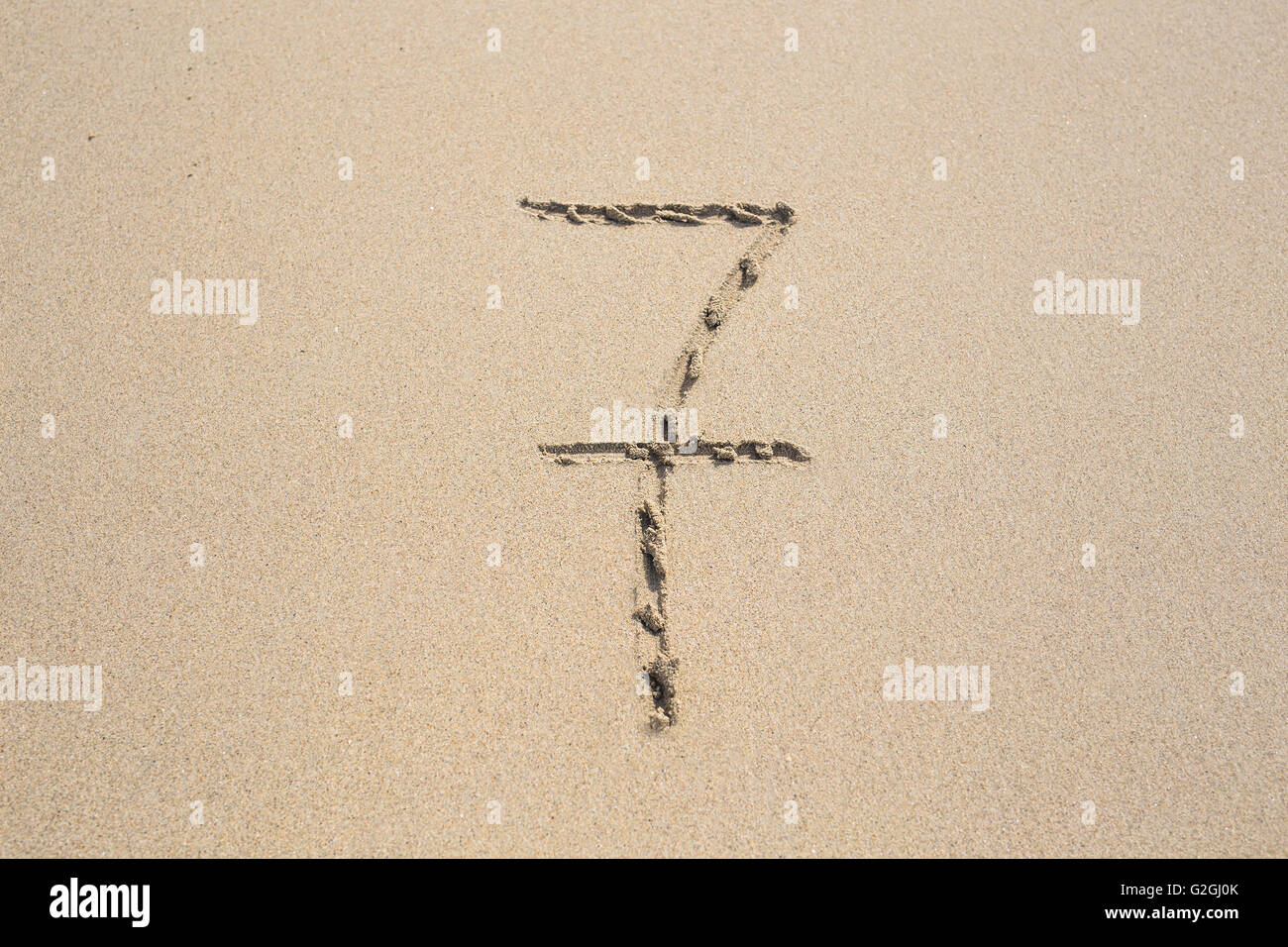Number seven on the Sand. Concept holiday background Stock Photo - Alamy