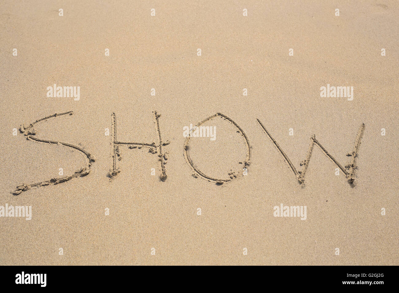 written word Show on sand of beach Stock Photo - Alamy