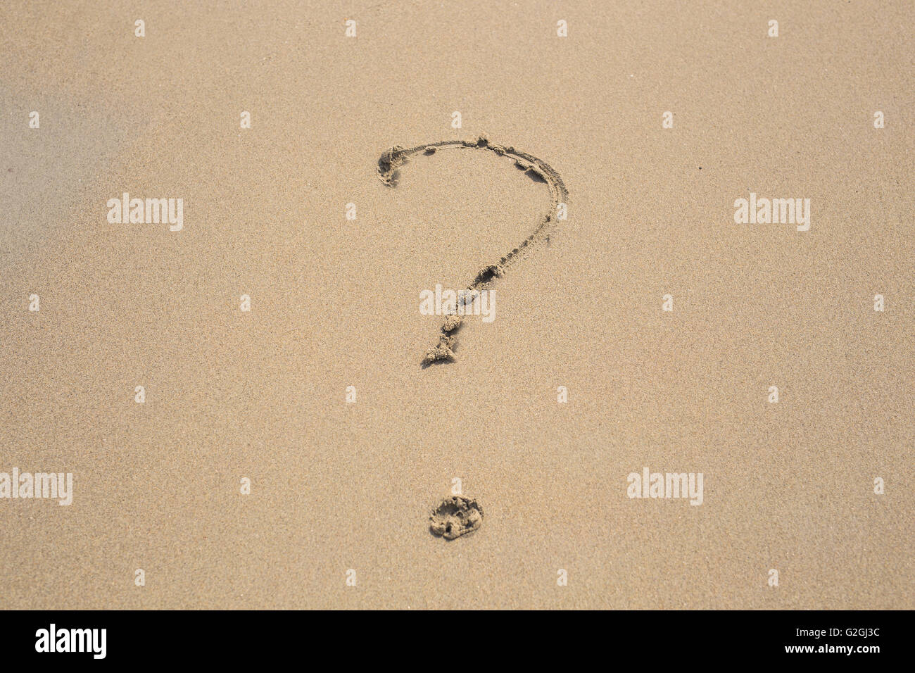 question mark drawn on the sand of a beach Stock Photo - Alamy