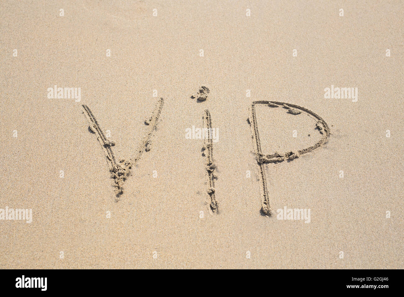 written word VIP on sand of beach Stock Photo - Alamy