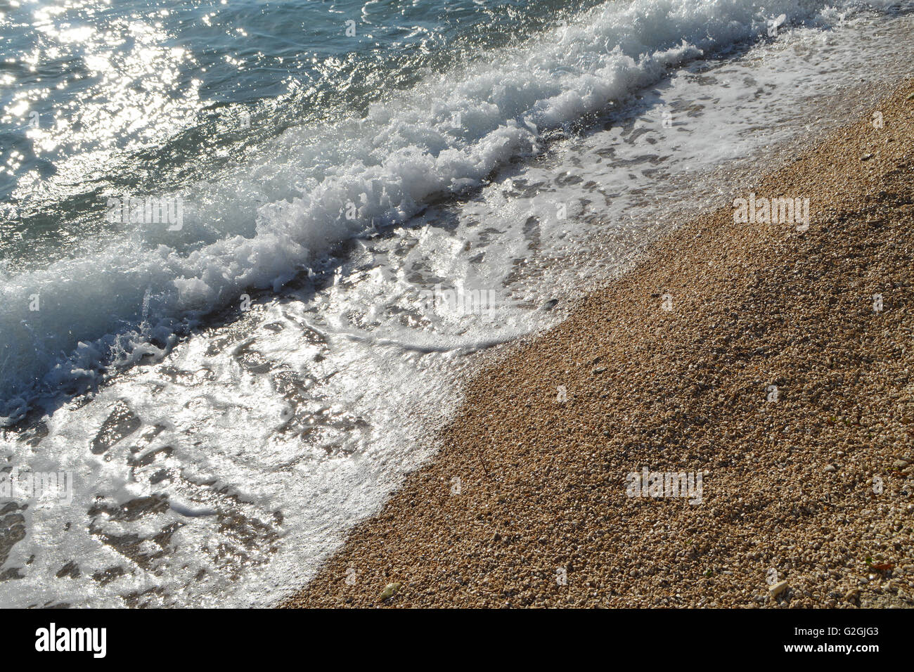 Sea water breaking the beach Stock Photo - Alamy