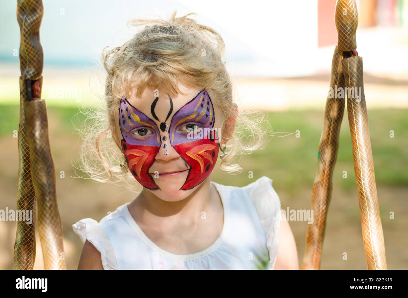beautiful blond girl with butterfly face painting Stock Photo - Alamy