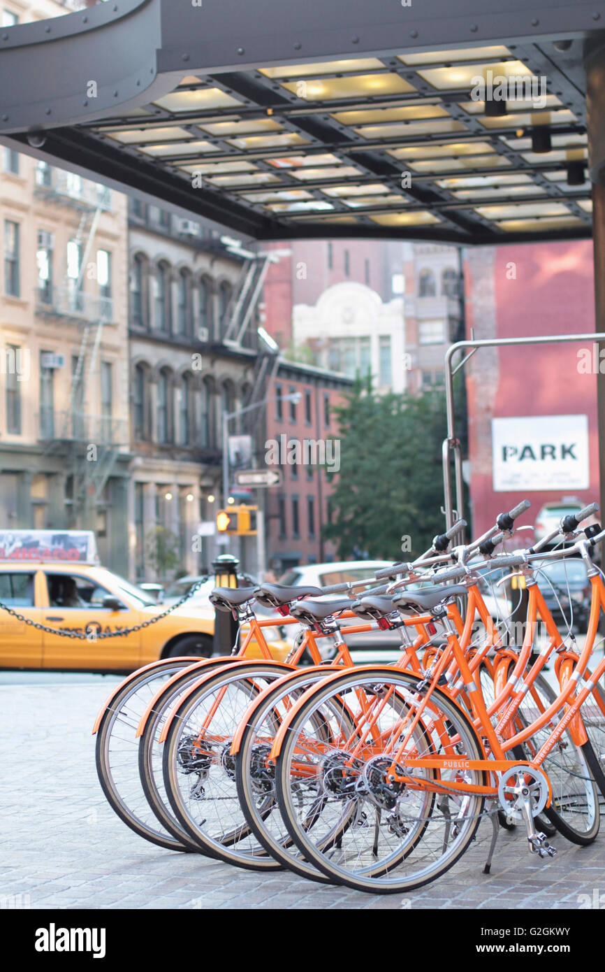 Row of Orange Bicycles and Taxi Outside Hotel, New York City, USA Stock ...