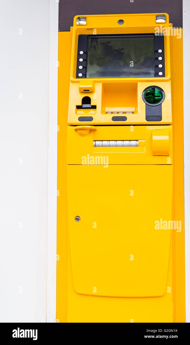 yellow ATM machine Stock Photo - Alamy