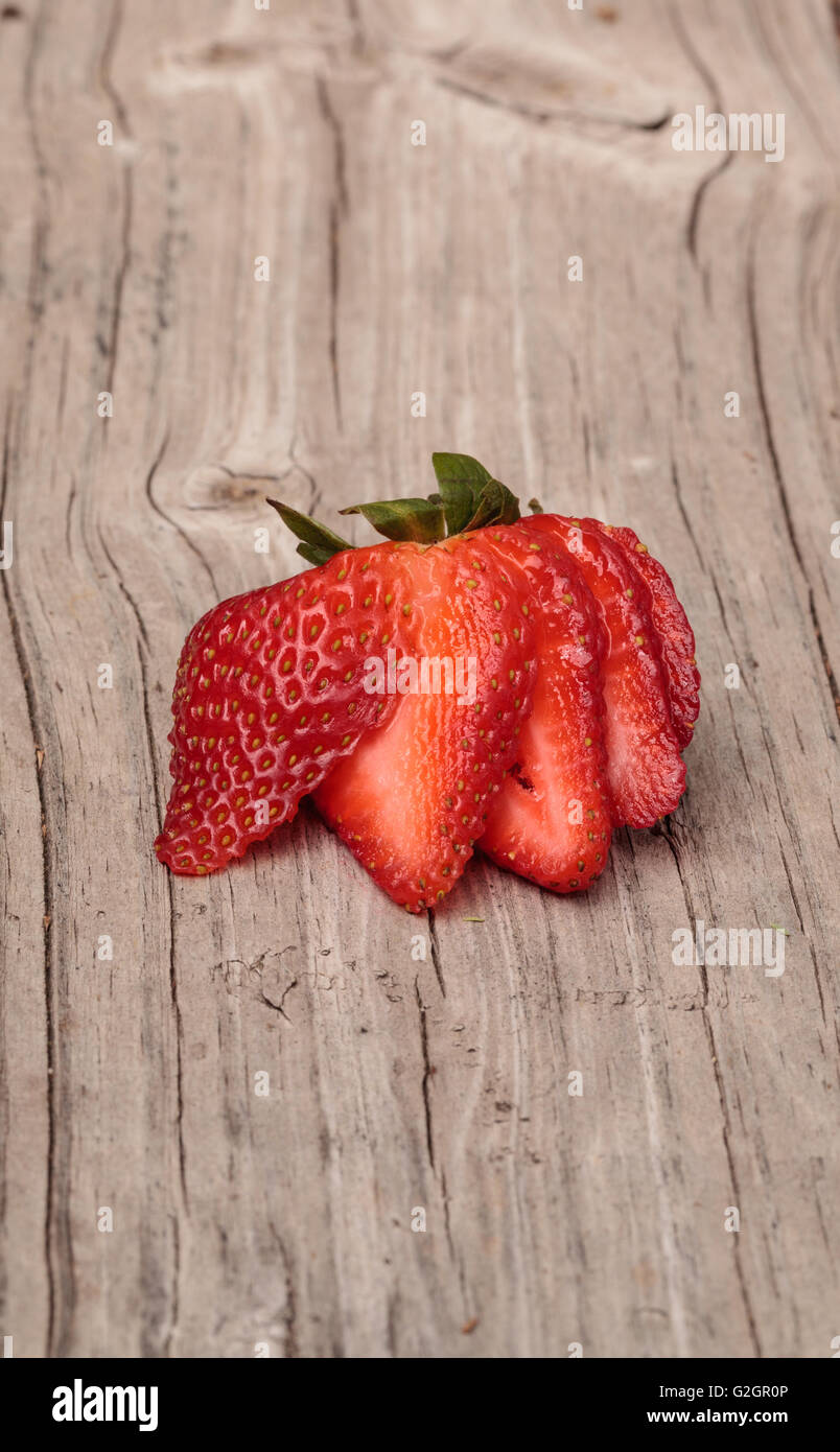 Sliced ripe strawberry on a rustic farm picnic table in summer Stock ...