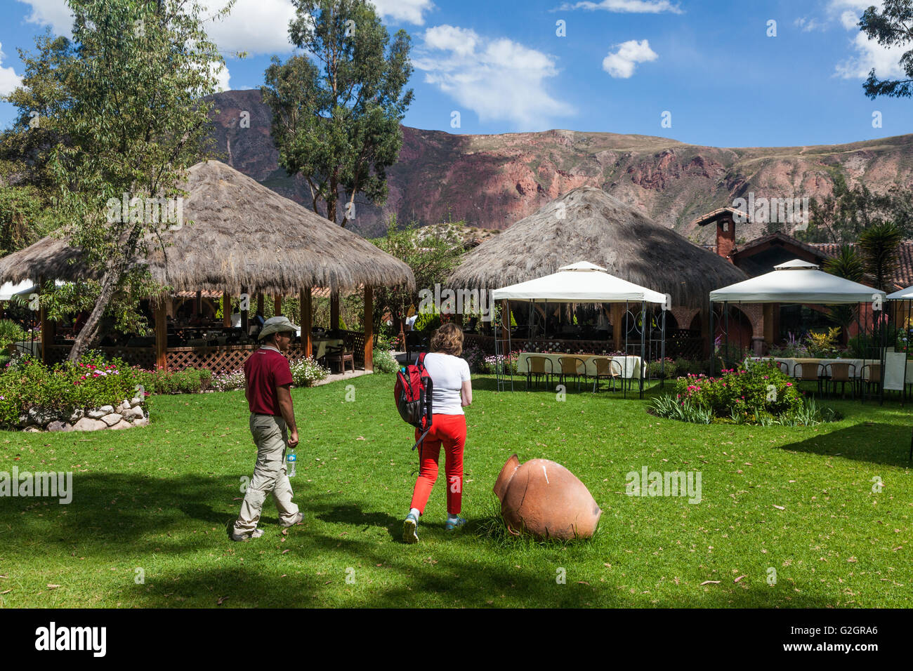 Two people walking in the grounds of the Alhambra Hacienda Restaurant ...