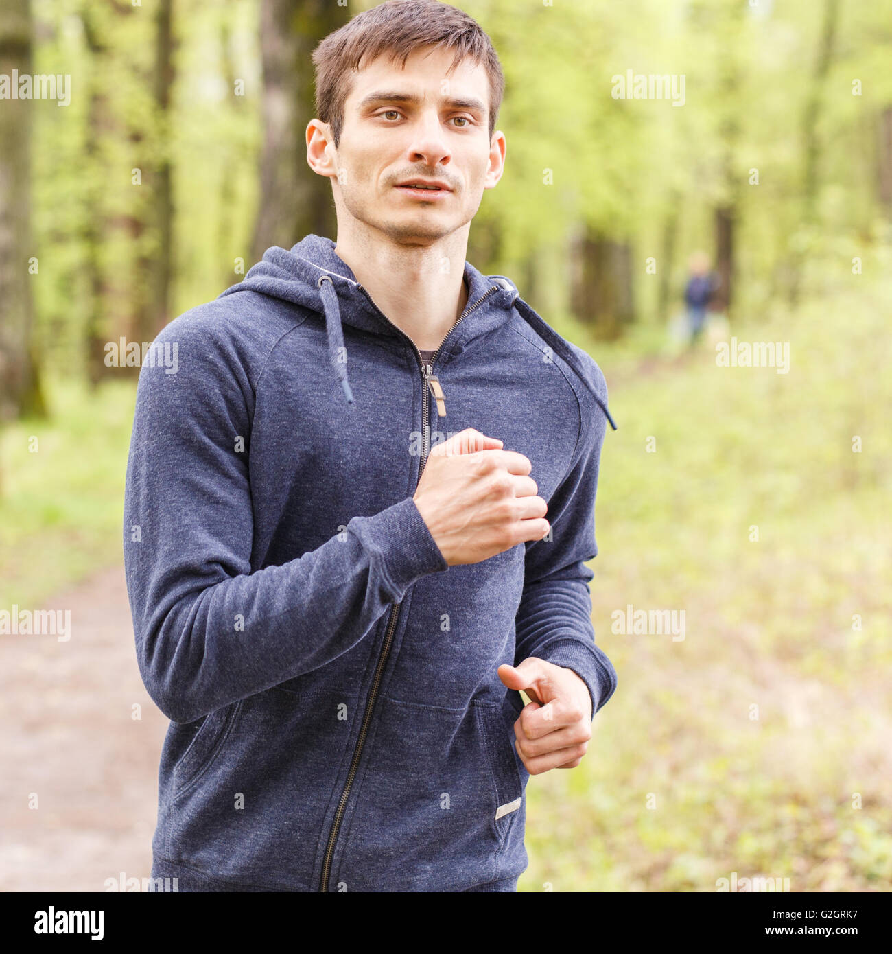 Young trail runner man jogging in the morning park. Sportsman running ...