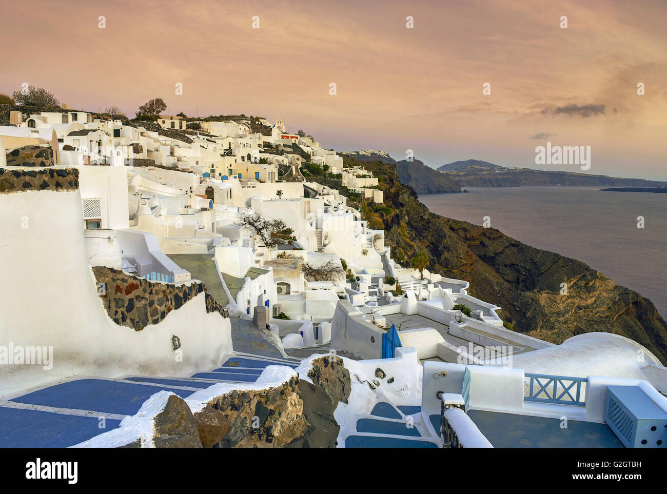 Sunset at Oia resort overlooking Imerovigli village in Santorini island ...