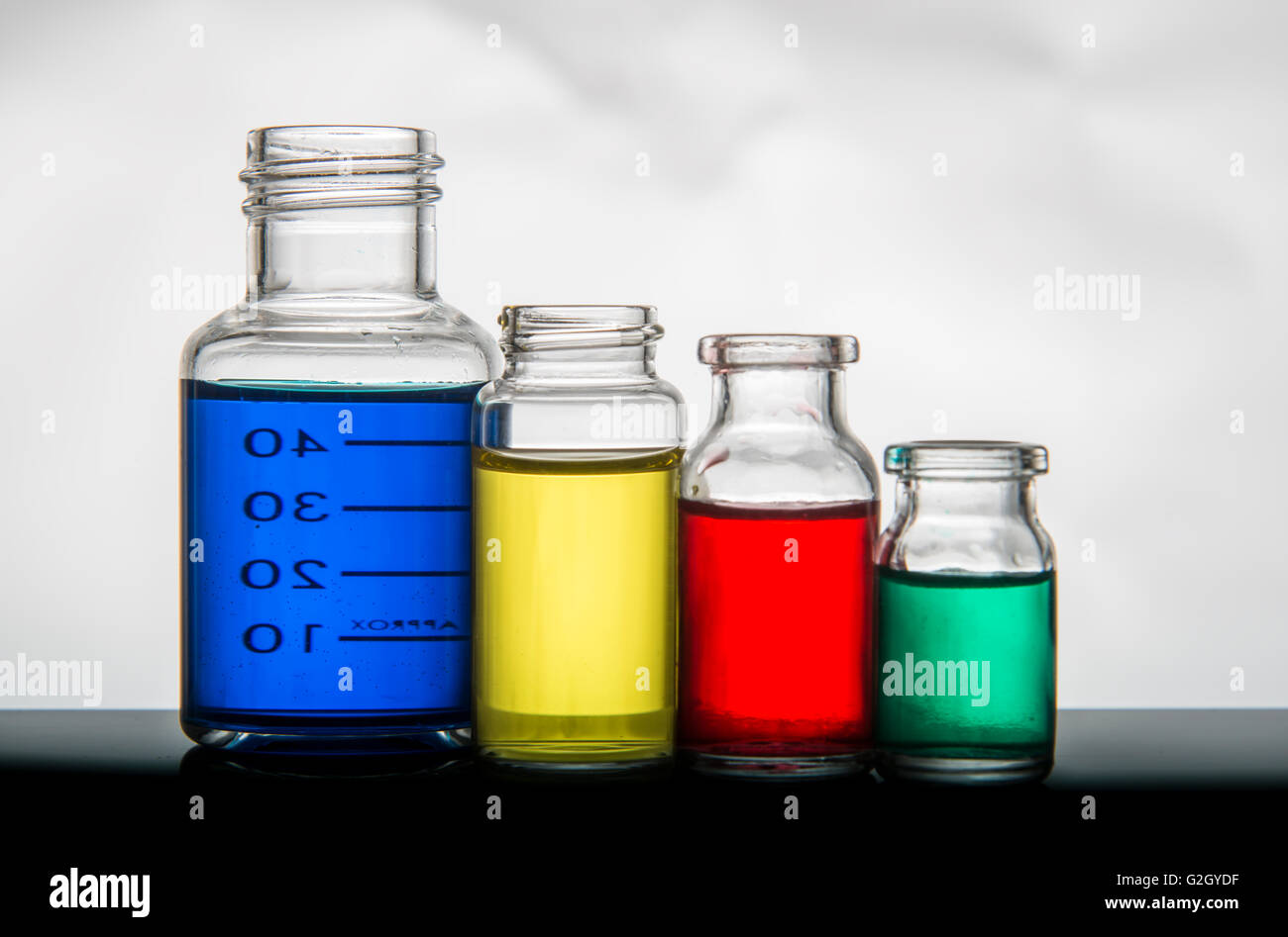 Set of laboratory bottles with color liquid Stock Photo - Alamy