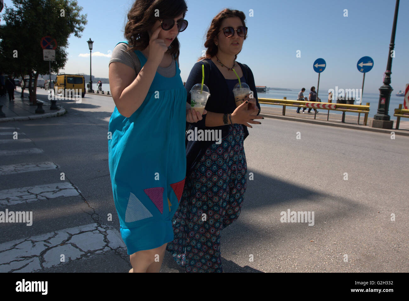 Two women walking and talking Stock Photo - Alamy