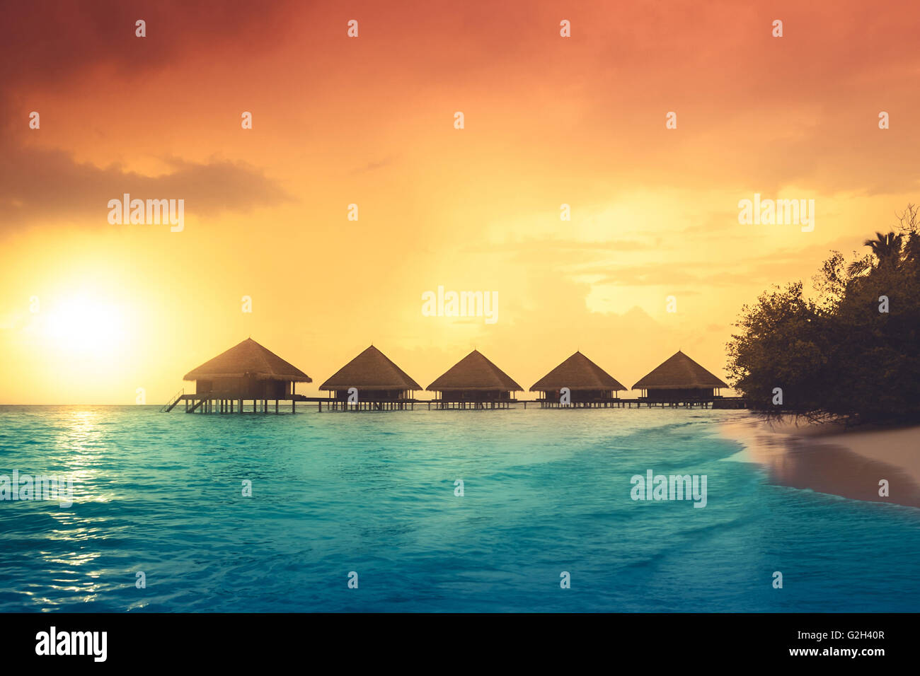 Sunset on Maldives island Stock Photo - Alamy
