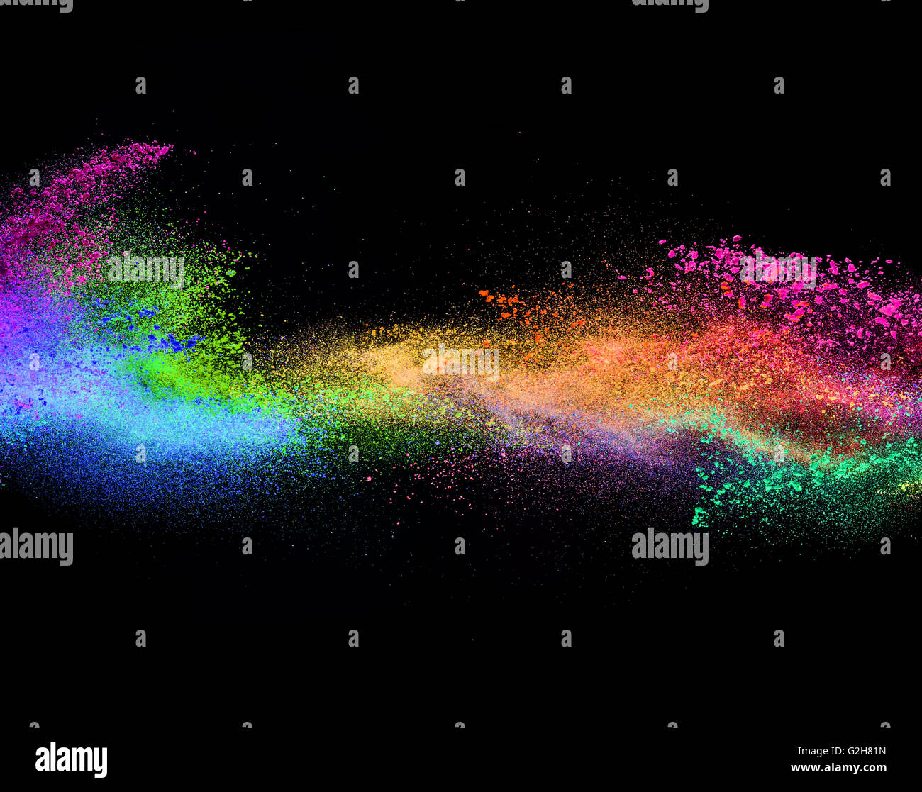 Colored powder exploding in abstract shape, isolated on black ...