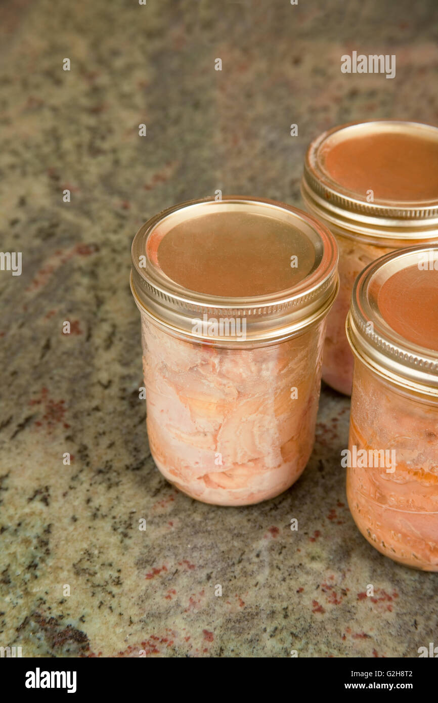 Jars of home canned tuna on a granite countertop Stock Photo - Alamy