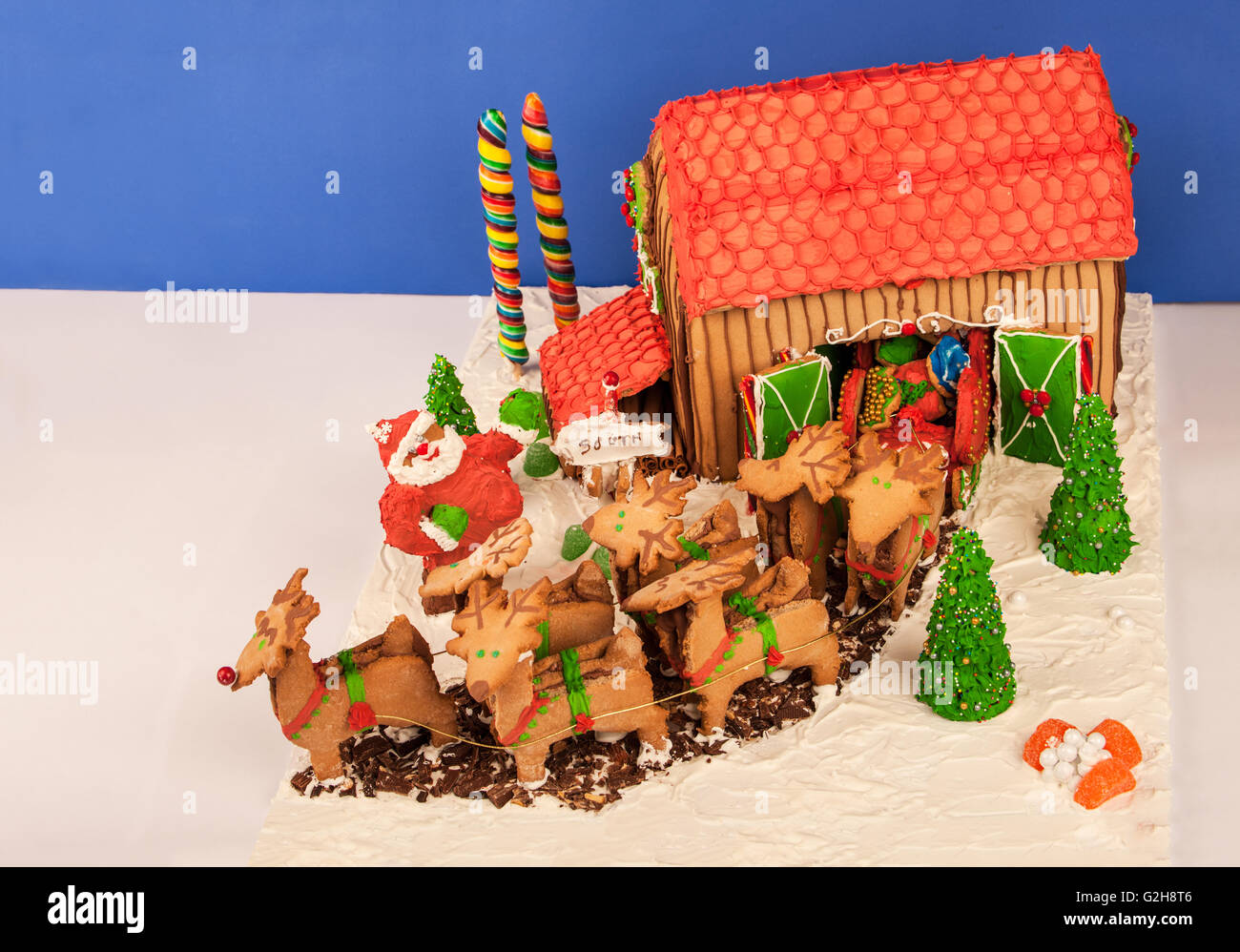 Homemade gingerbread setup of Santa's barn, sled, reindeer and Santa ...