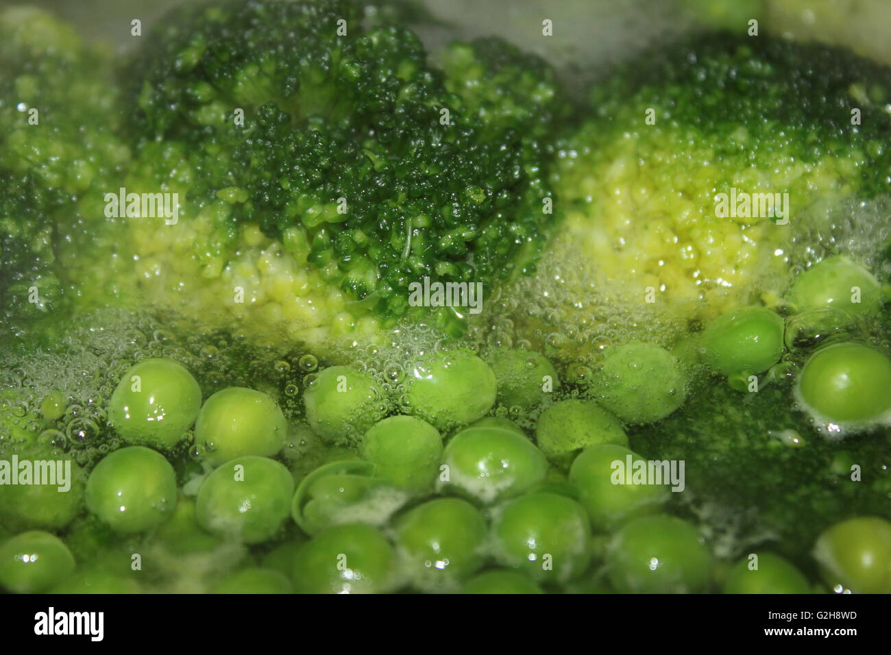 Peas and broccoli boiling together Stock Photo - Alamy