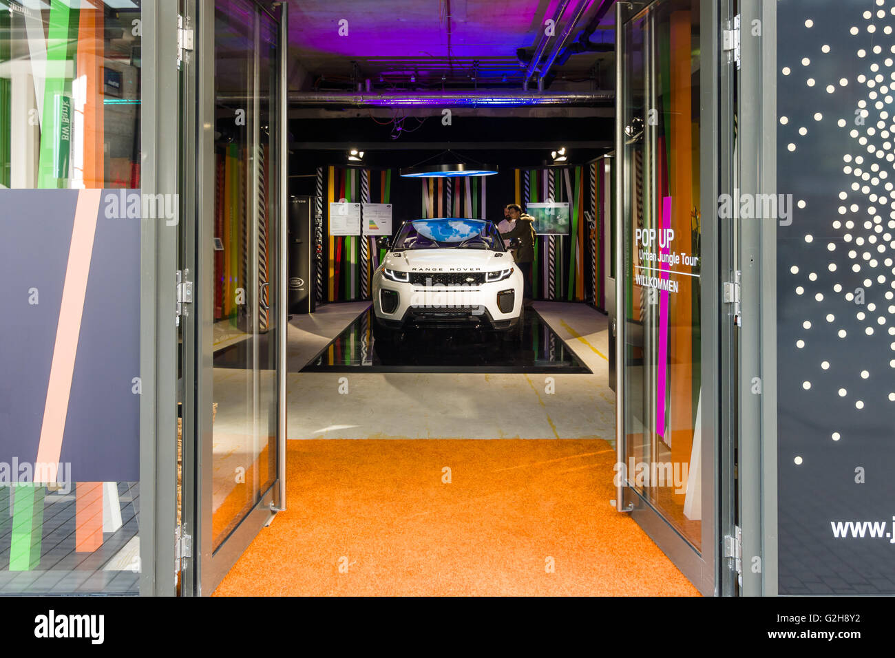 Land Rover showroom and a car Range Rover Evoque. Historical Street ...
