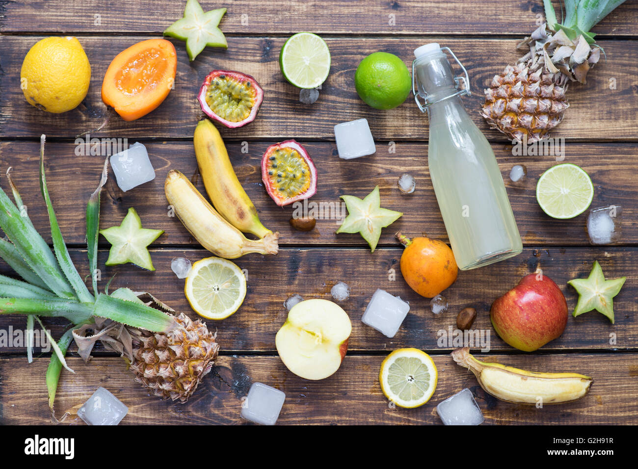 Tropical fruits with ice and bottle of soda Stock Photo - Alamy