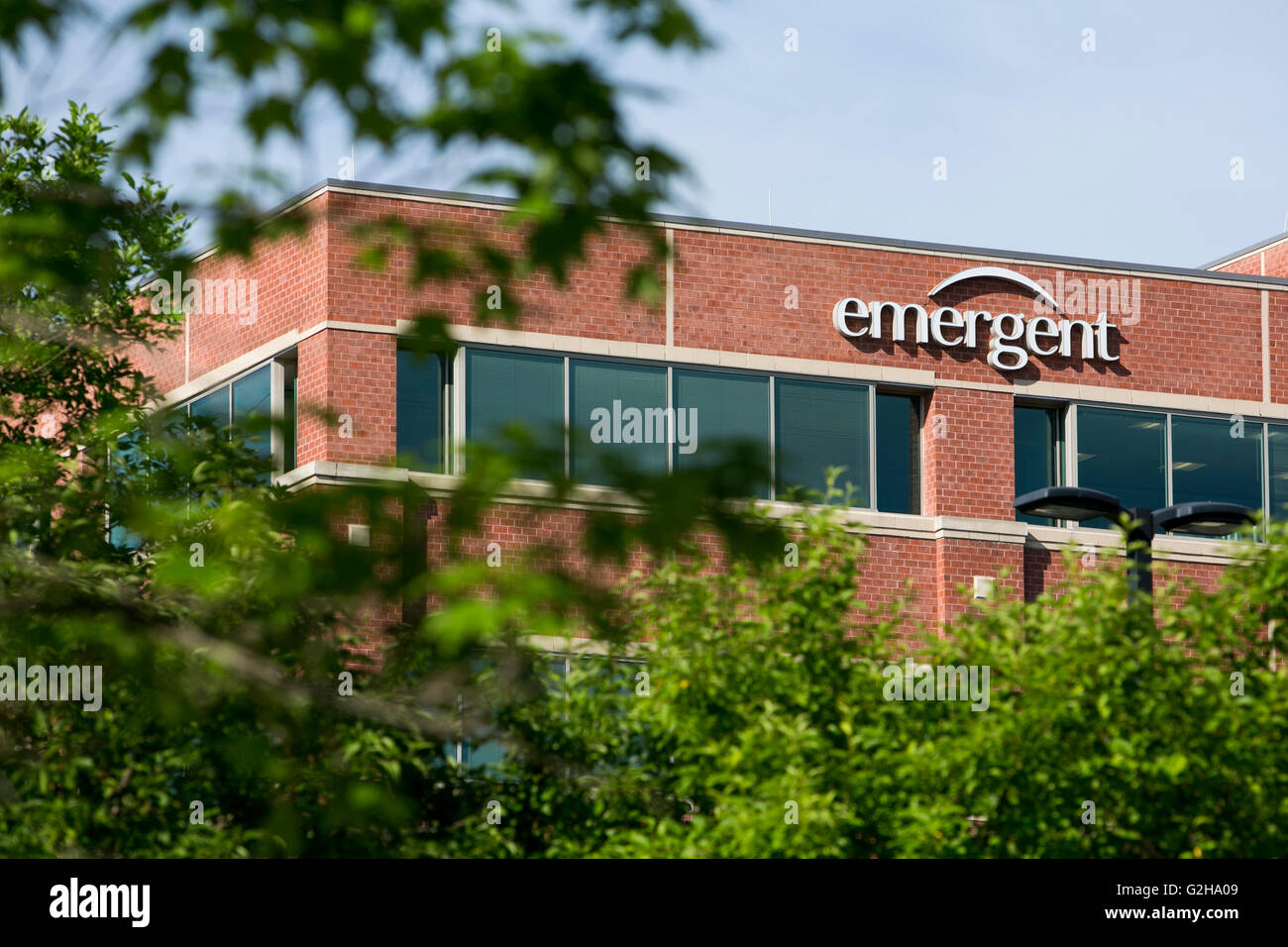 A logo sign outside of the headquarters of Emergent BioSolutions in ...