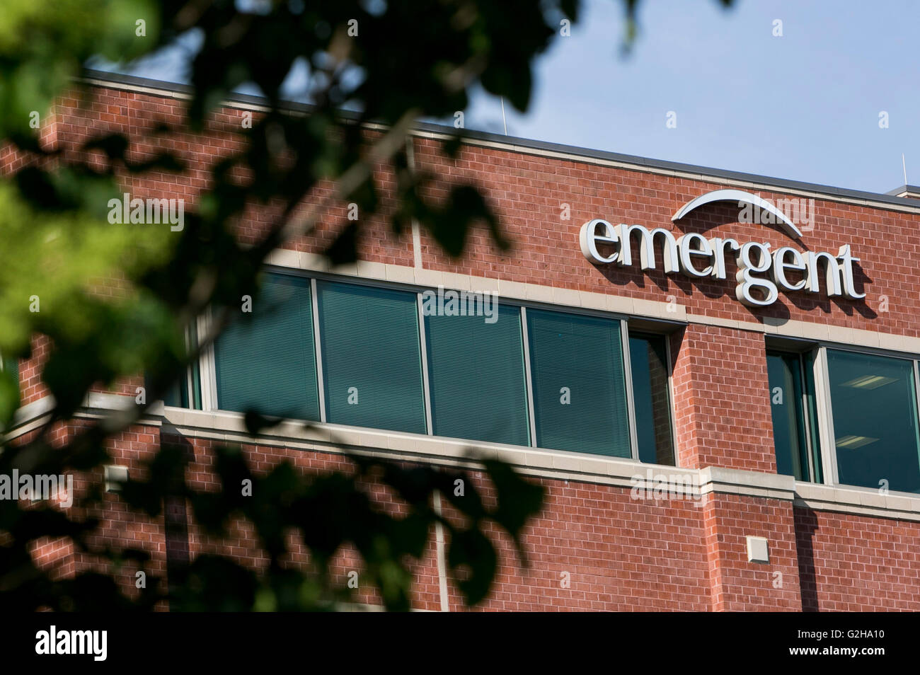 A logo sign outside of the headquarters of Emergent BioSolutions in ...