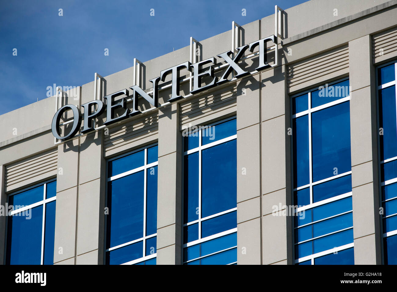 A logo sign outside of a facility occupied by the OpenText Corporation ...