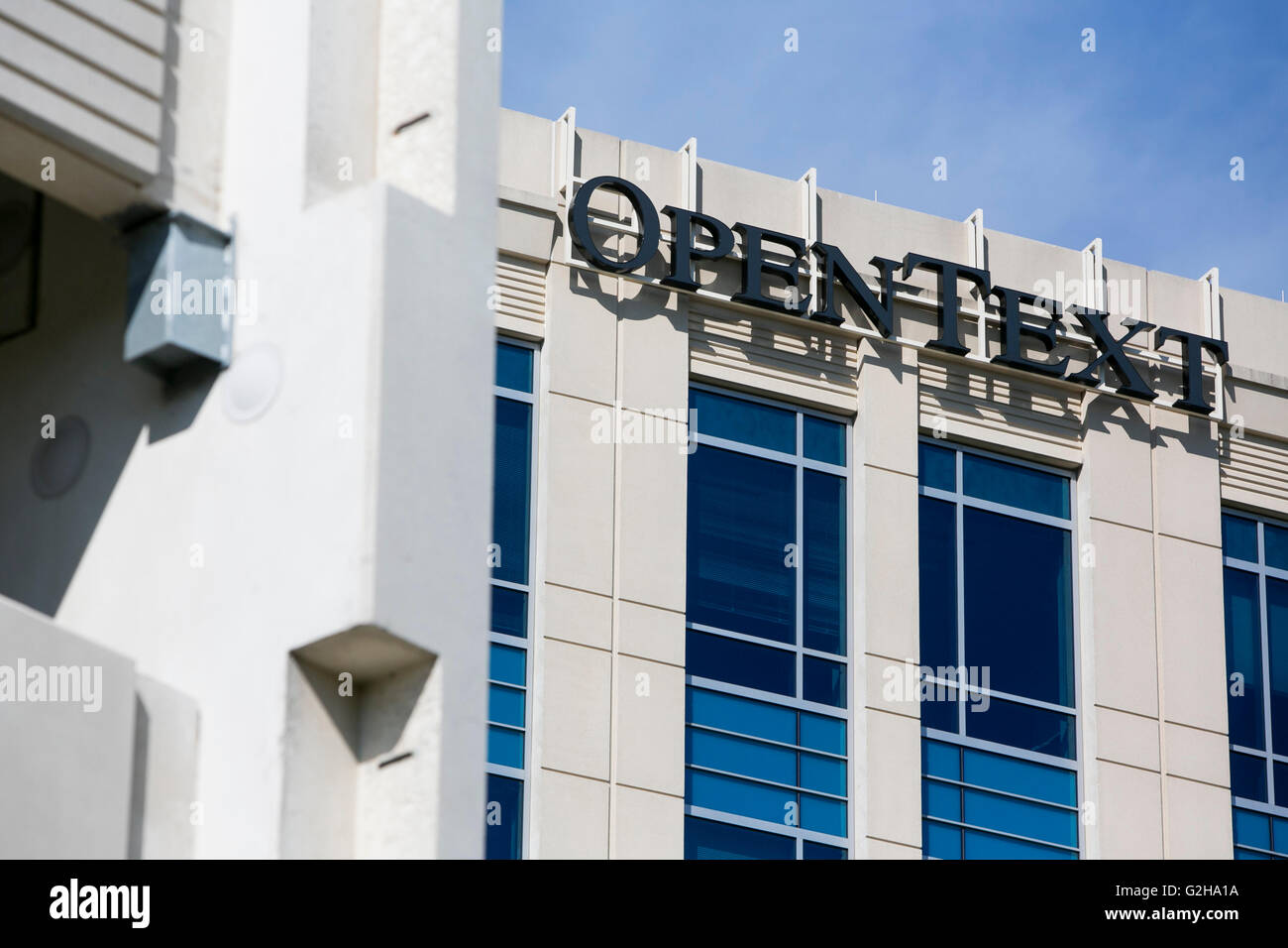 A logo sign outside of a facility occupied by the OpenText Corporation ...