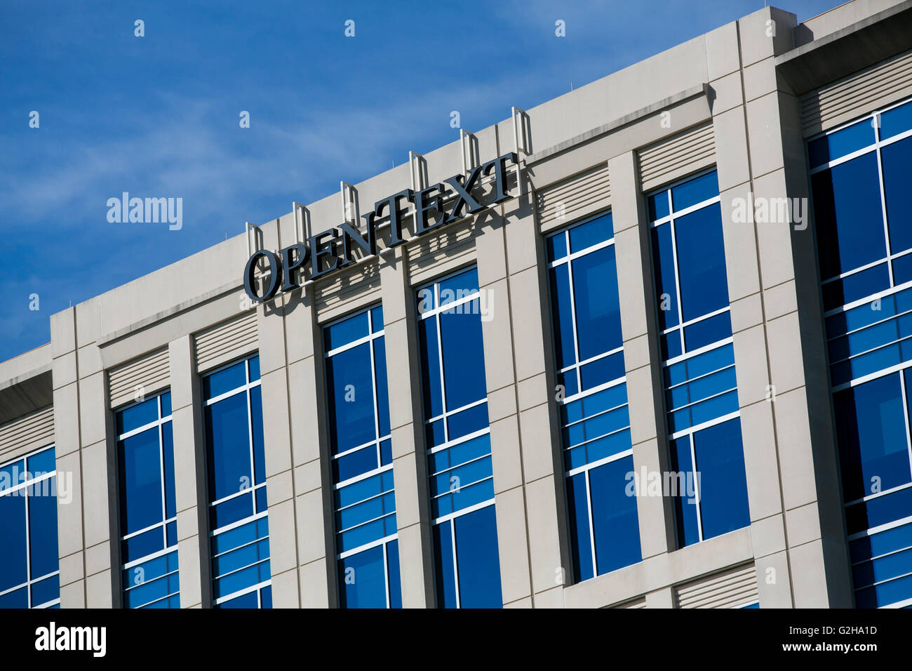 A logo sign outside of a facility occupied by the OpenText Corporation ...