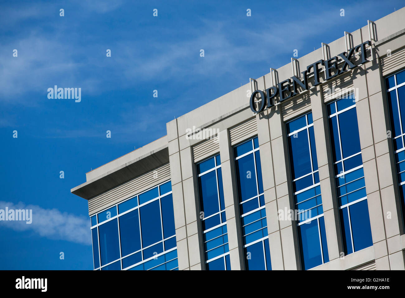 A logo sign outside of a facility occupied by the OpenText Corporation ...