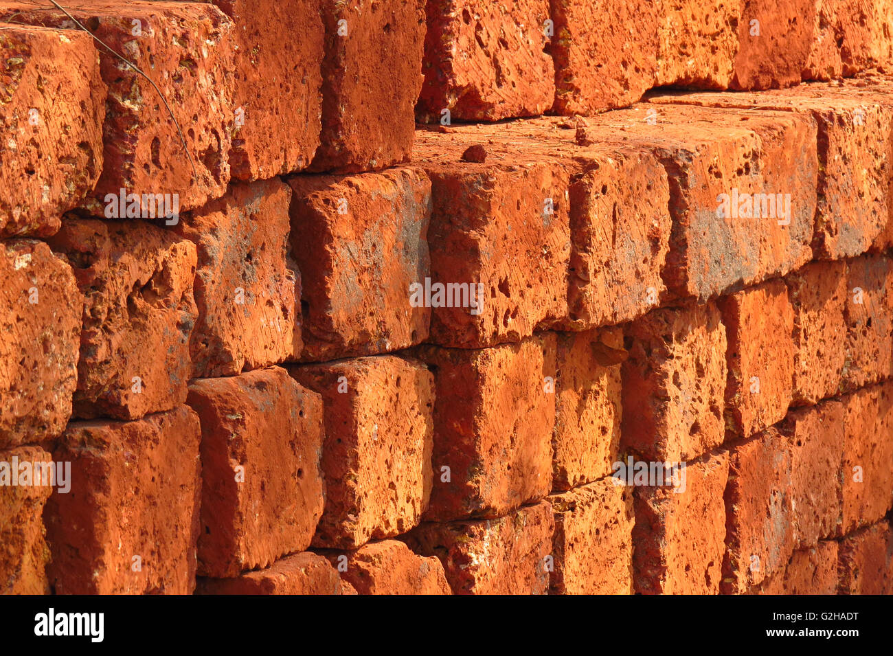 A background of a stack of red bricks at a construction site Stock ...