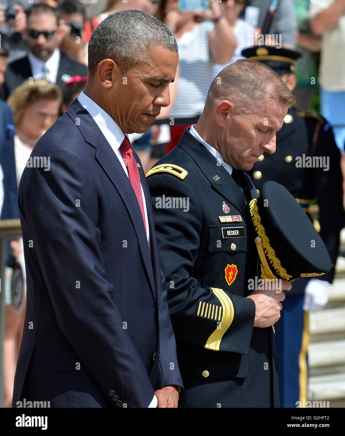 United States President Barack Obama (L) bows his head in silence along ...