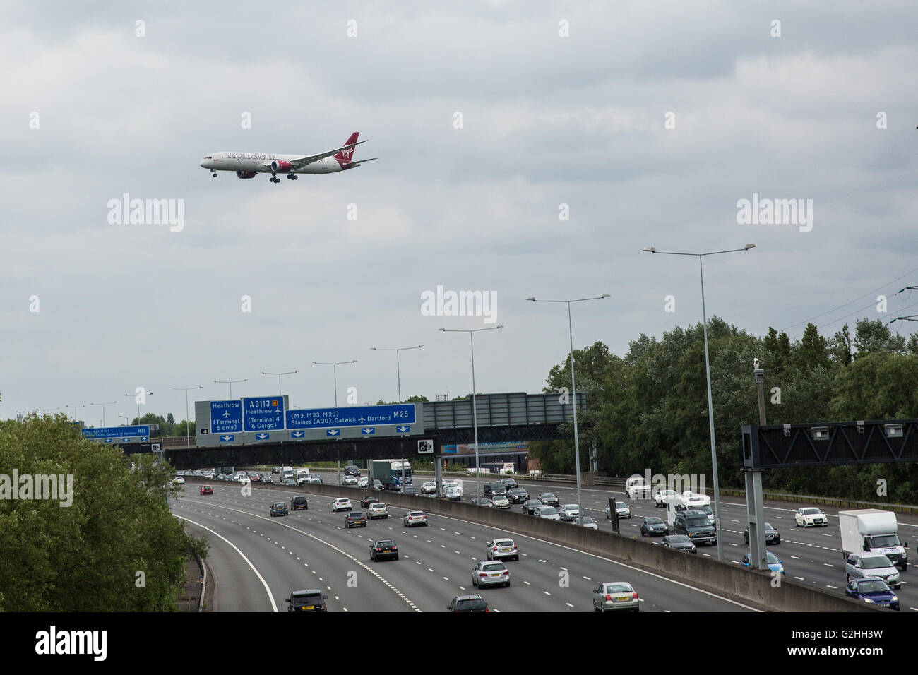Harmondsworth, UK. 30th May, 2016. A Virgin Airlines plane flies into ...