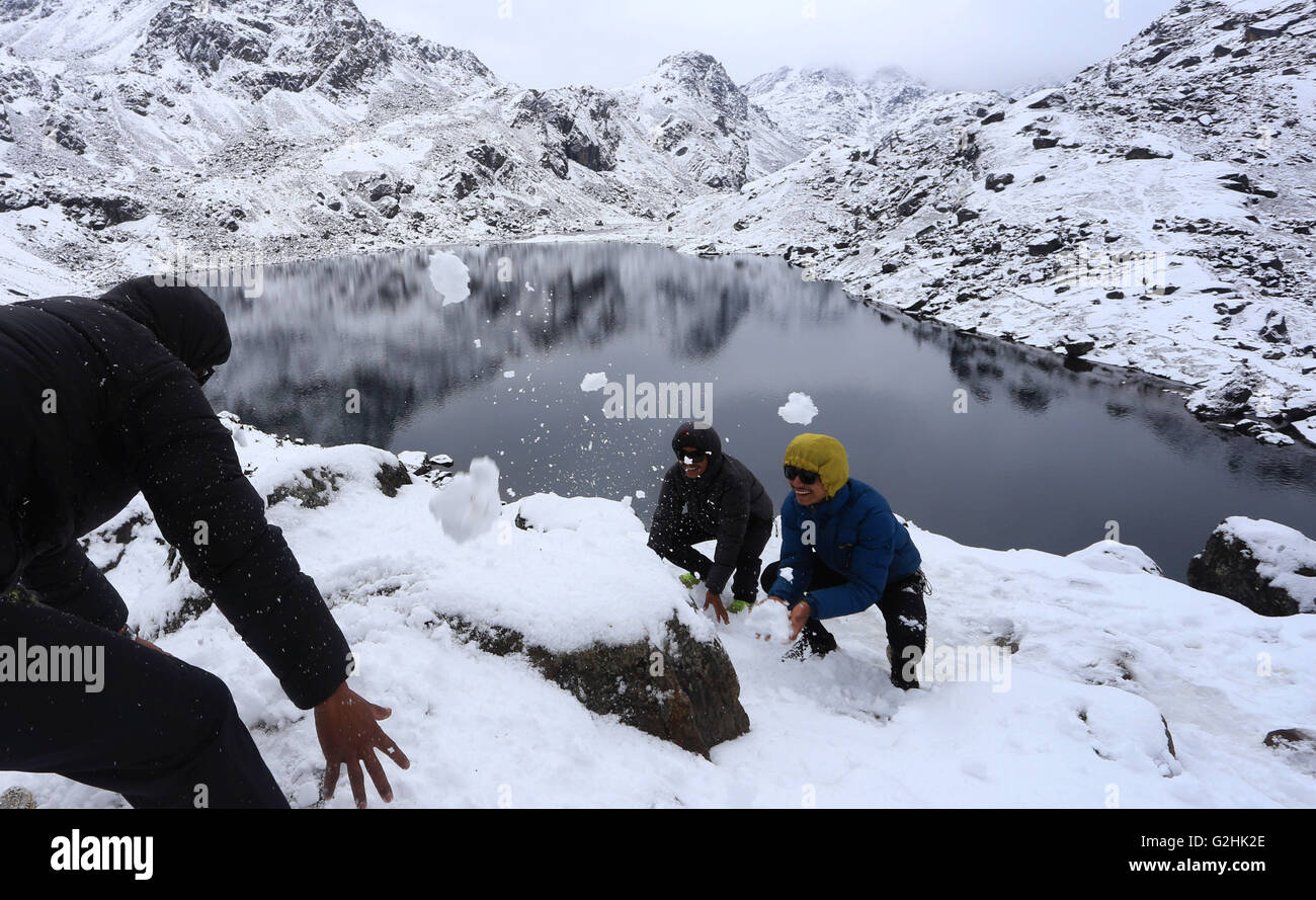 Rasuwa, Nepal. 30th May, 2016. Nepalese people play with snow after a ...