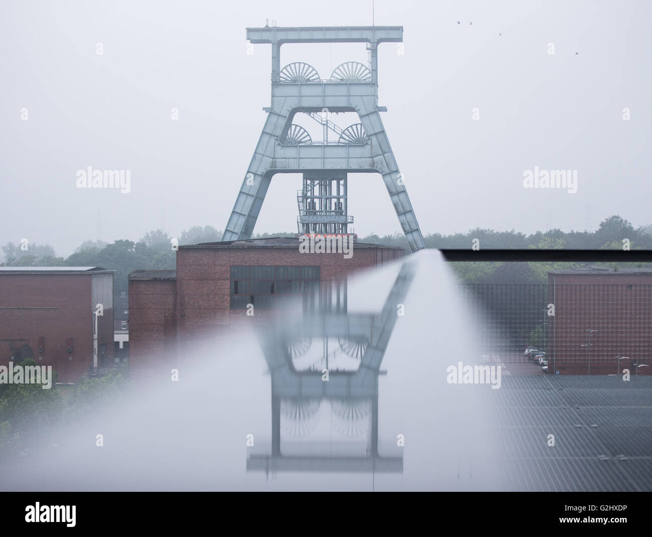 The pit frame of the coal mine Ewald mirrors on the wet surface of a ...