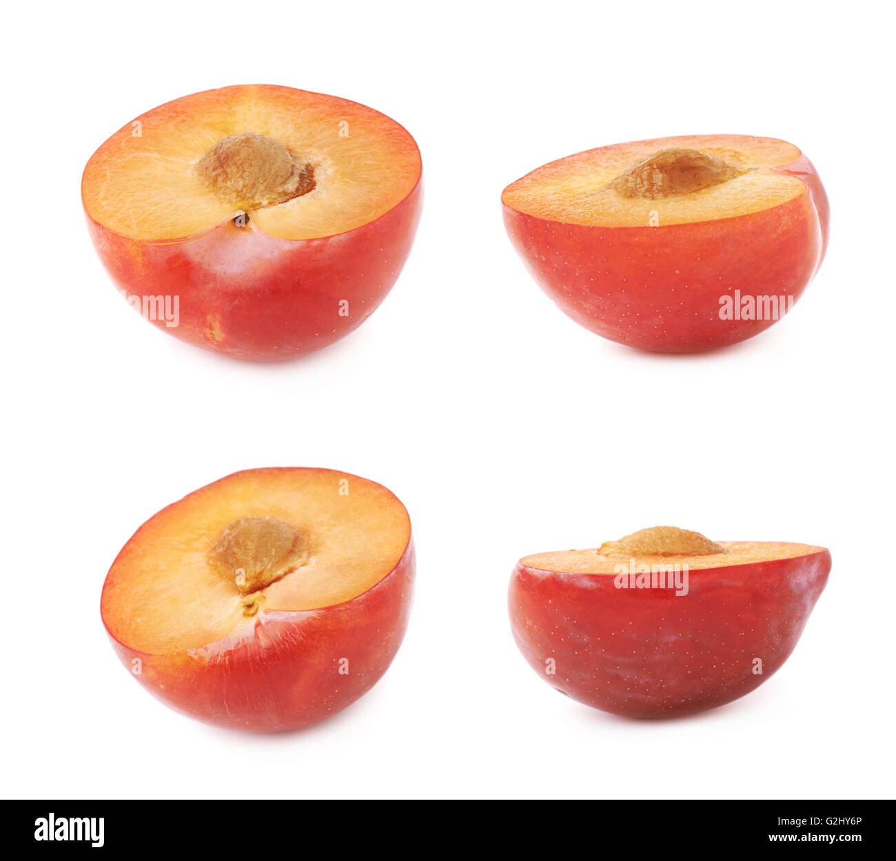 Cut open plum half isolated Stock Photo - Alamy