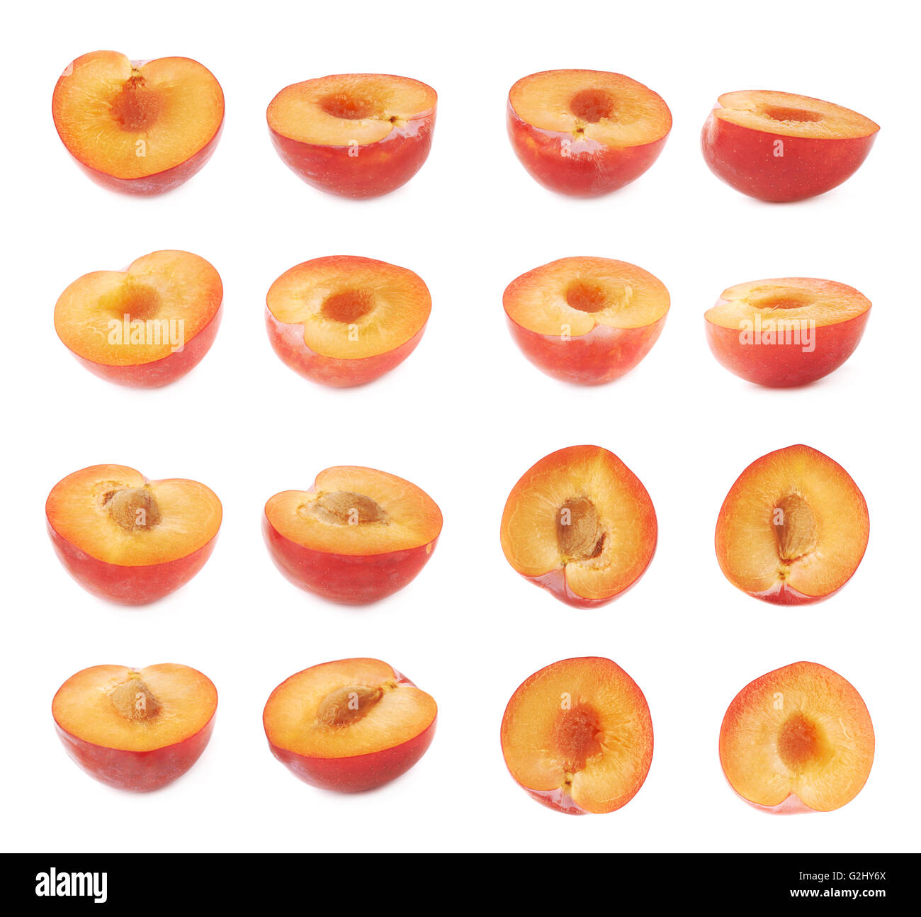 Cut open plum half isolated Stock Photo - Alamy