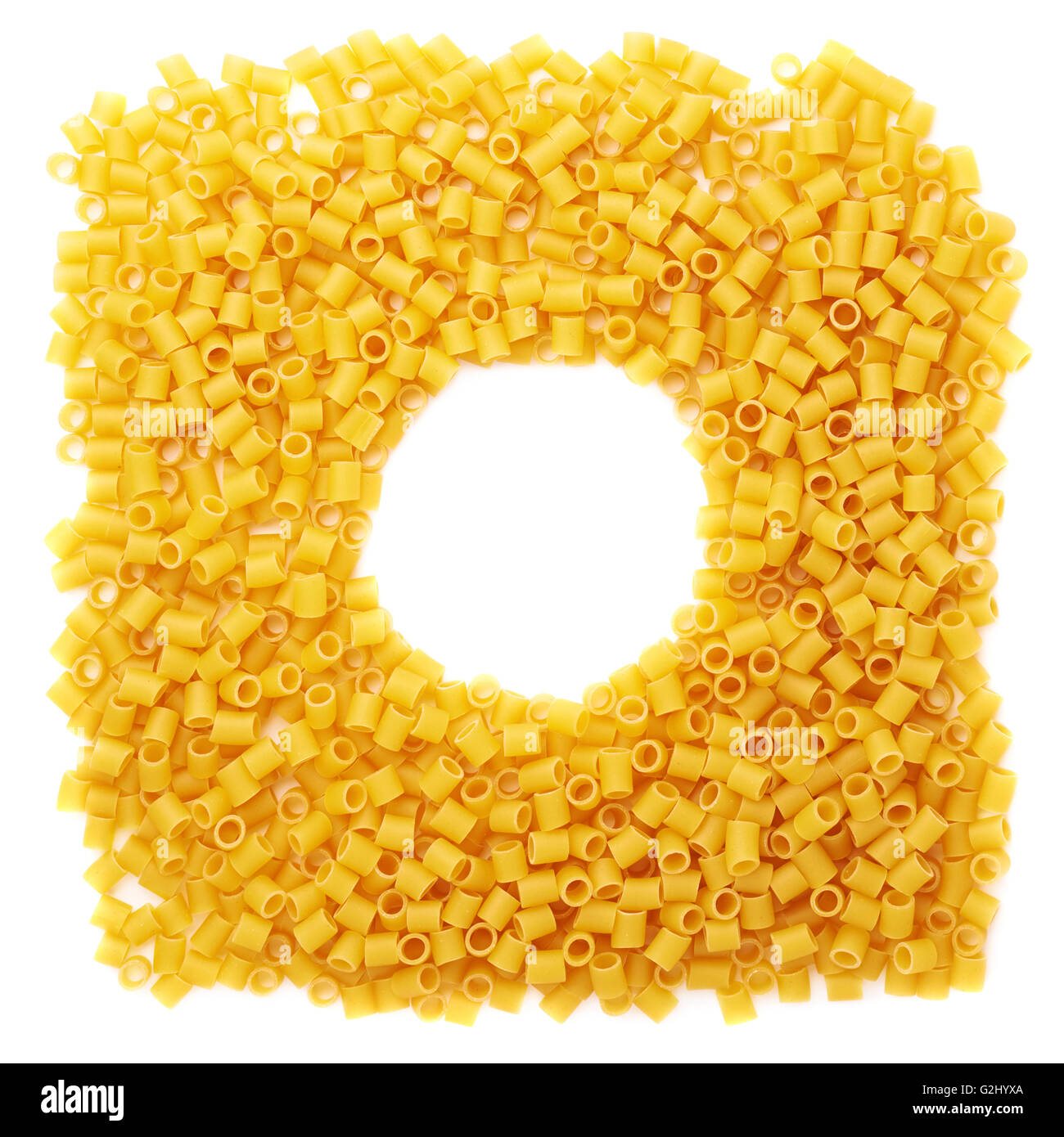 Round frame made of dry ditalini pasta over isolated white background ...