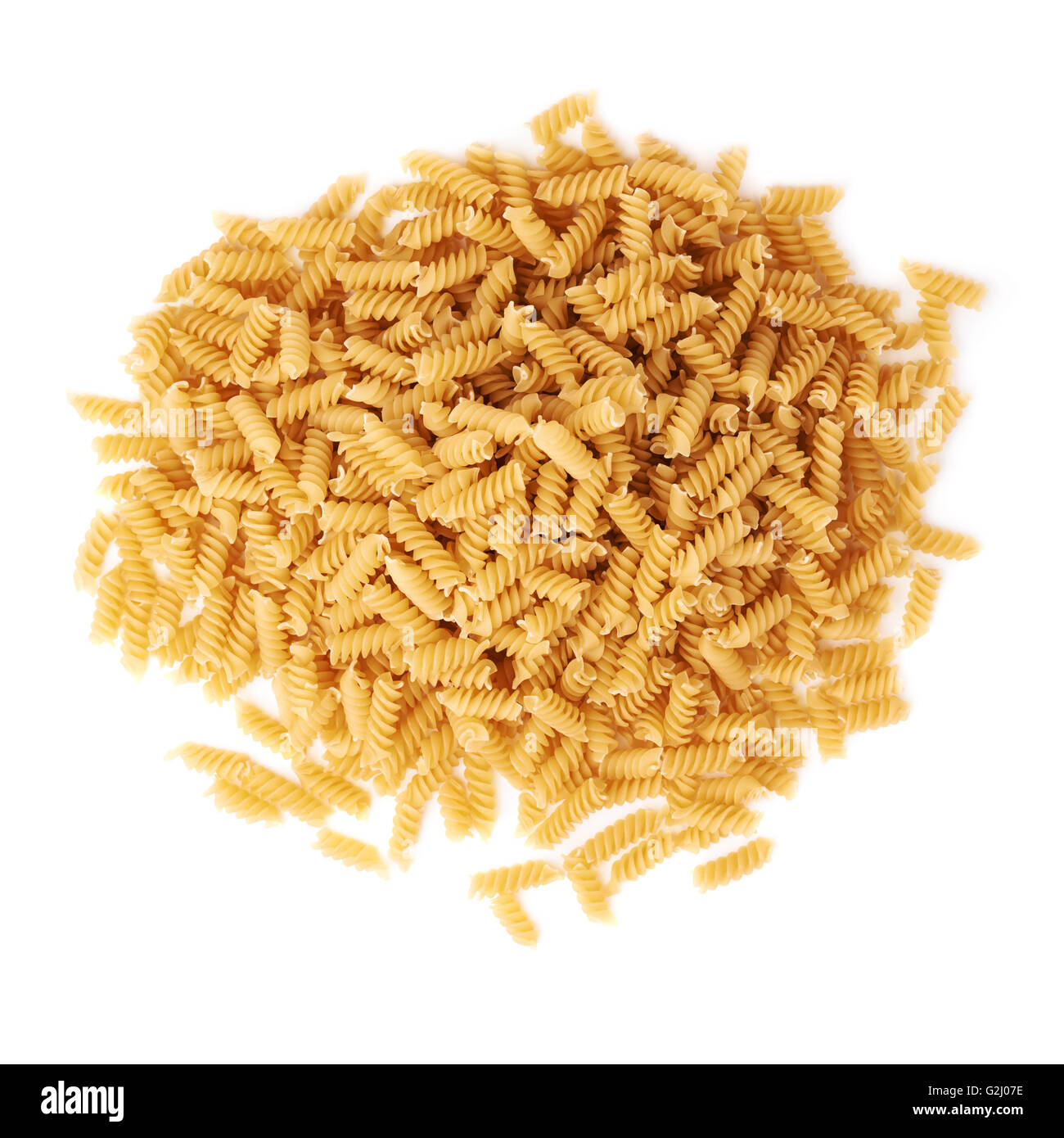 Pile of dry rotini pasta over isolated white background Stock Photo - Alamy
