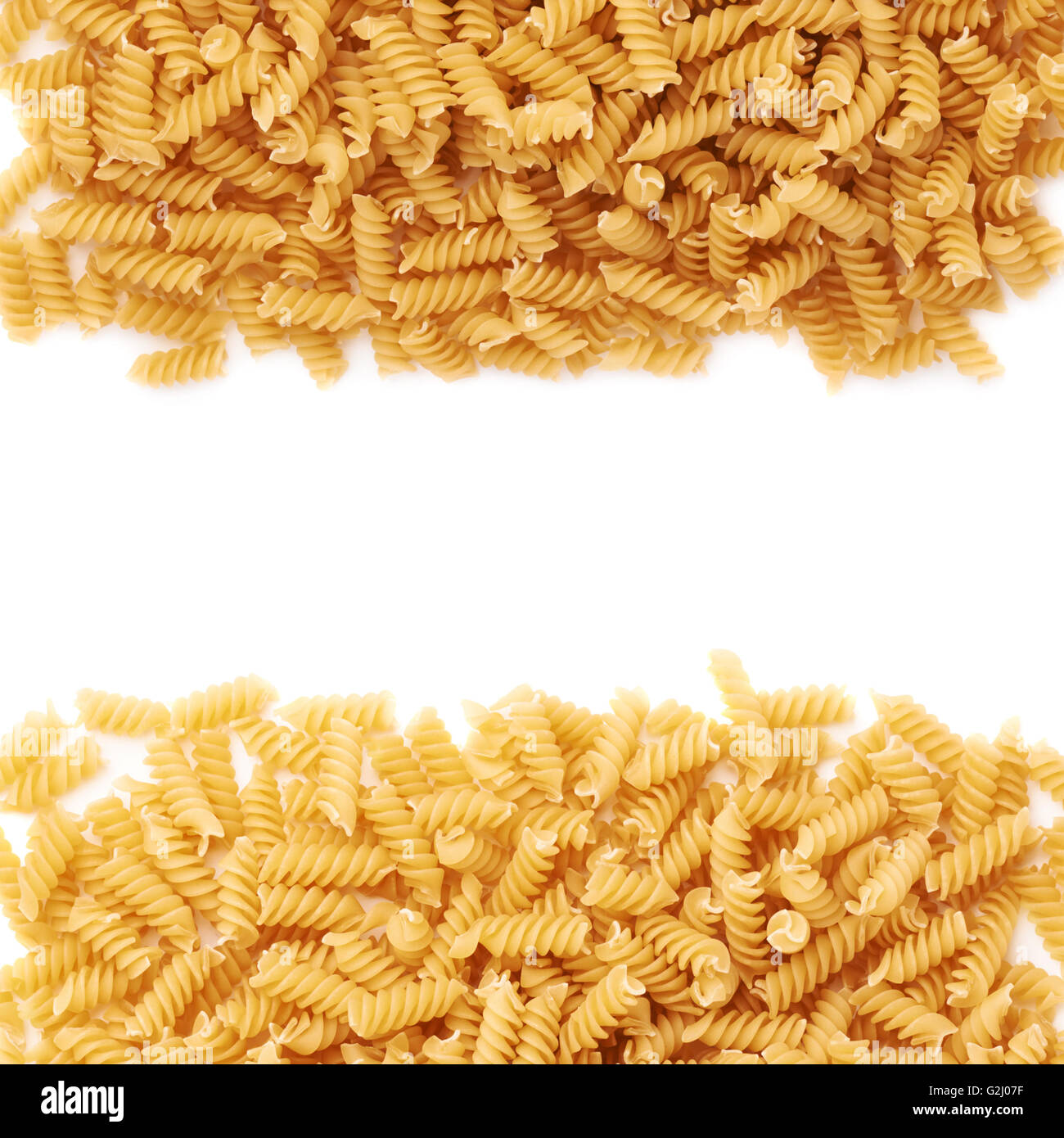 Pile of dry rotini pasta over isolated white background Stock Photo - Alamy
