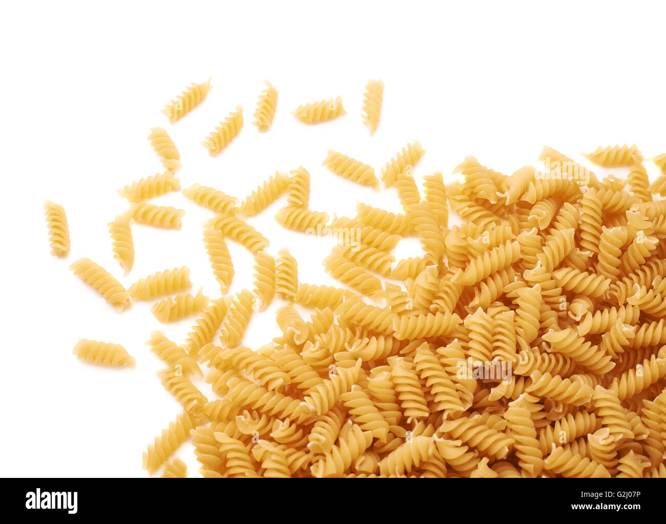 Pile of dry rotini pasta over isolated white background Stock Photo - Alamy