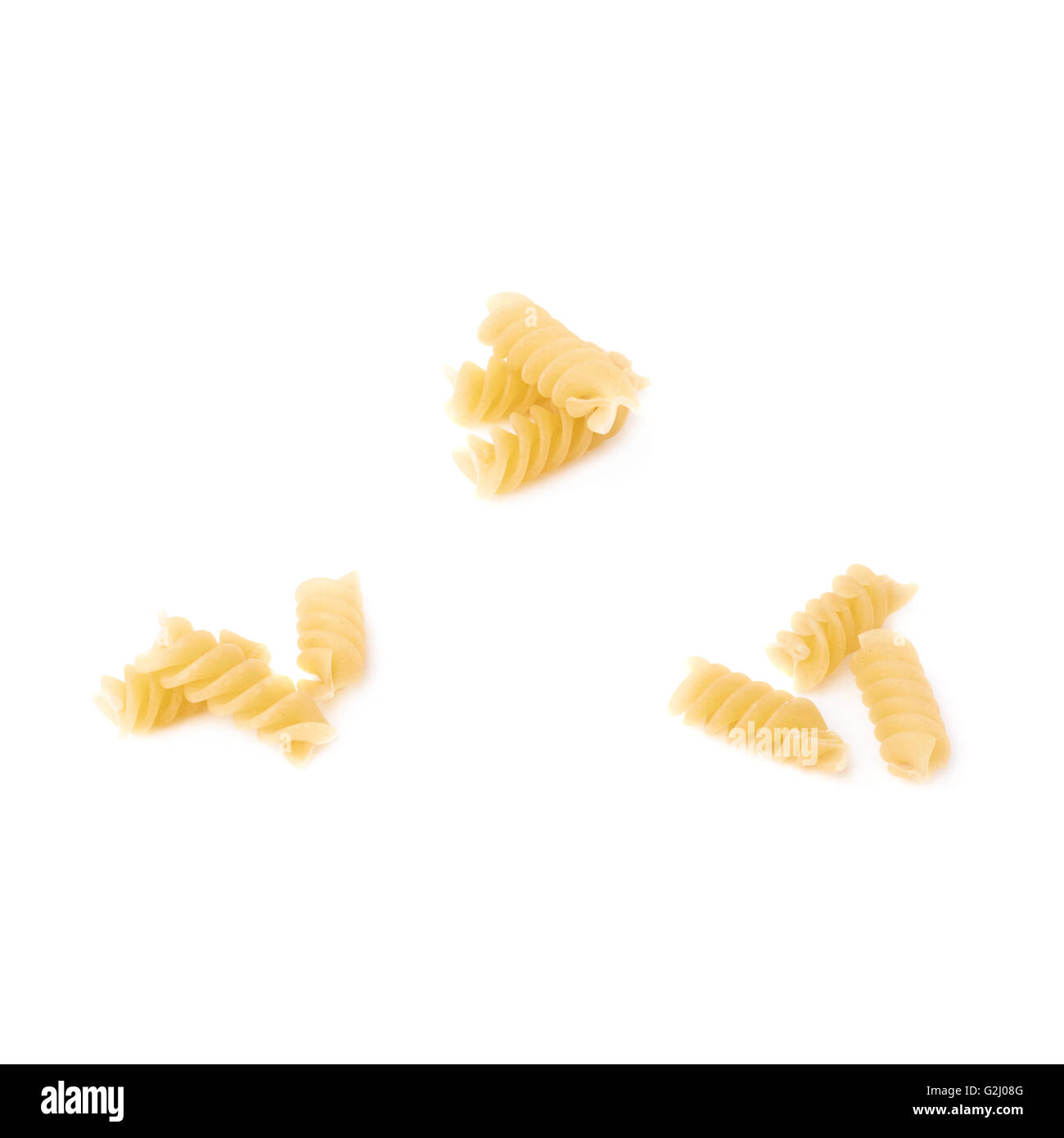 Pile of dry pasta rotini over isolated white background Stock Photo - Alamy