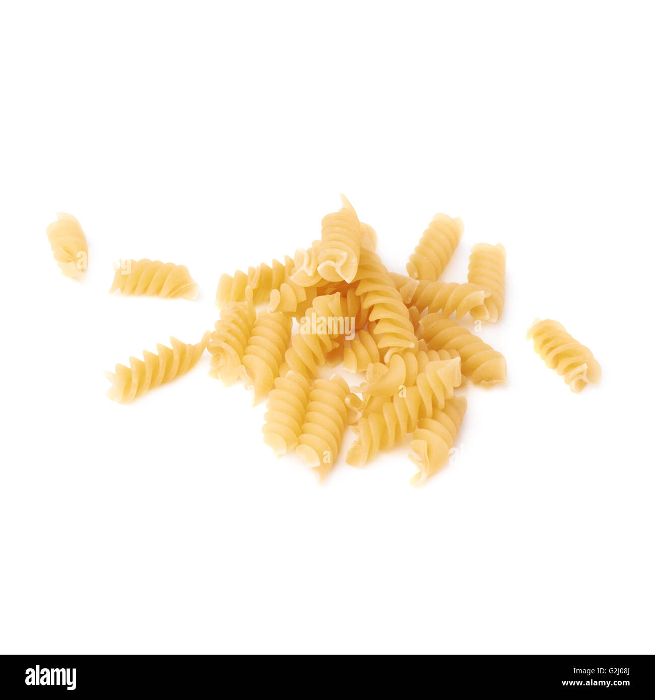 Pile of dry pasta rotini over isolated white background Stock Photo - Alamy