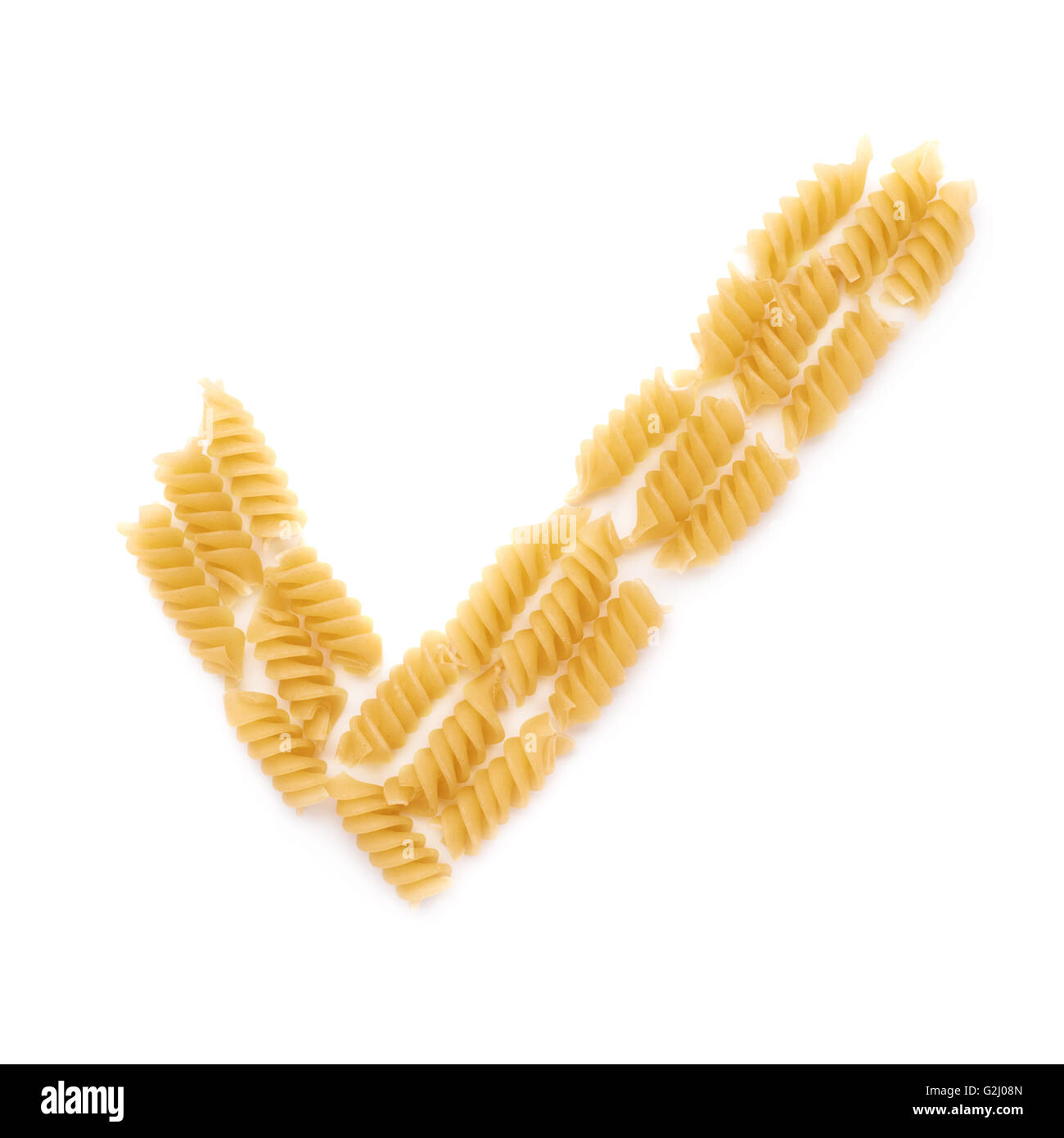Yes tick sign symbol mark made of dry rotini pasta over isolated white ...