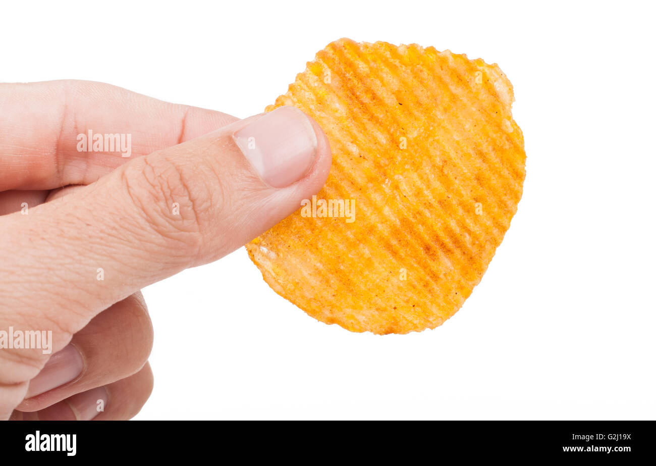 Hand holding single spiced potato chip isolated on white background ...
