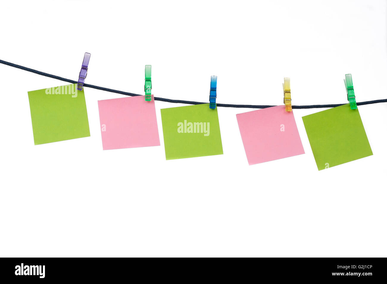 Coloured memos on string with clothespin isolated on white background ...