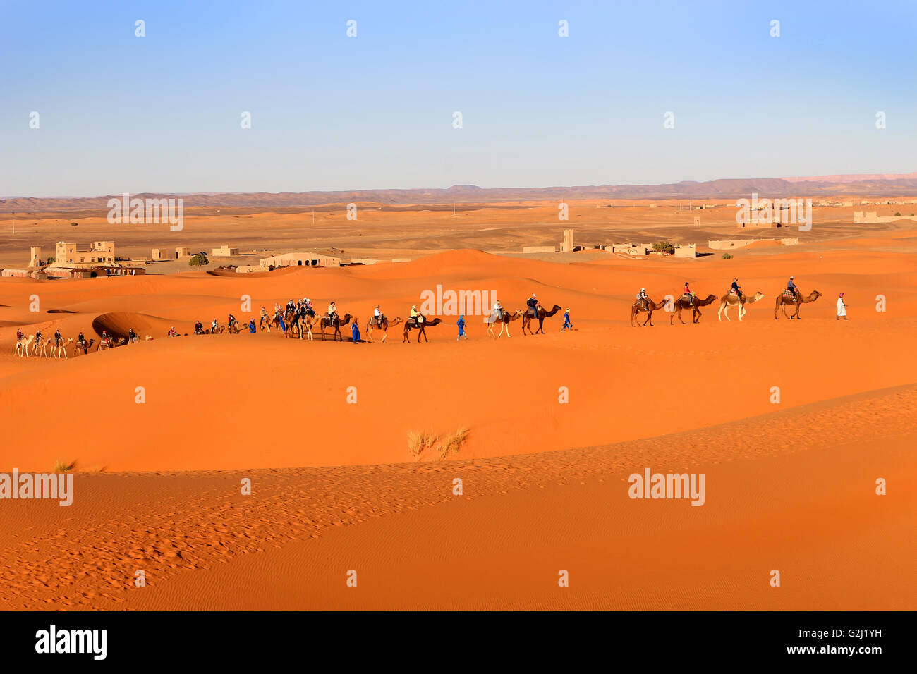 ERG CHEGGI, MOROCCO - FEBRUARY 28, 2016: People riding on a caravan of ...