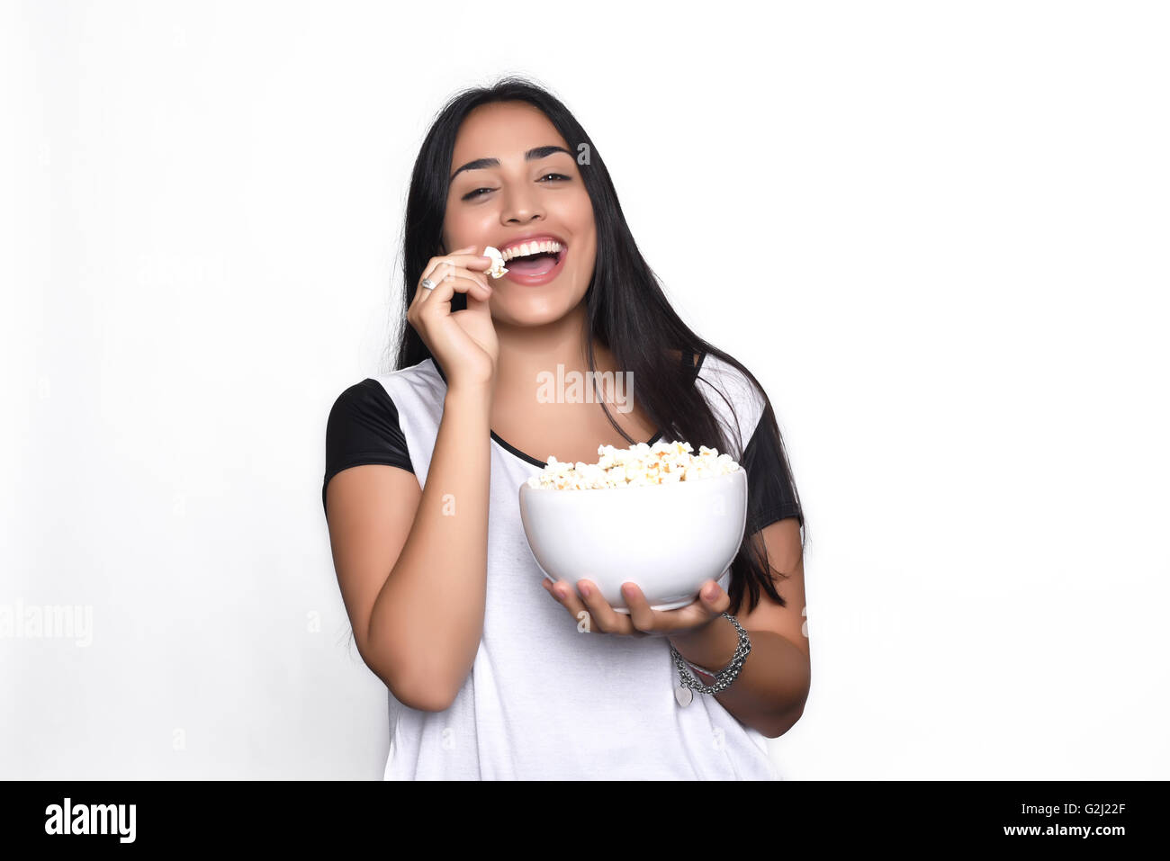 Young beautiful woman eating popcorn. Isolated white background Stock ...